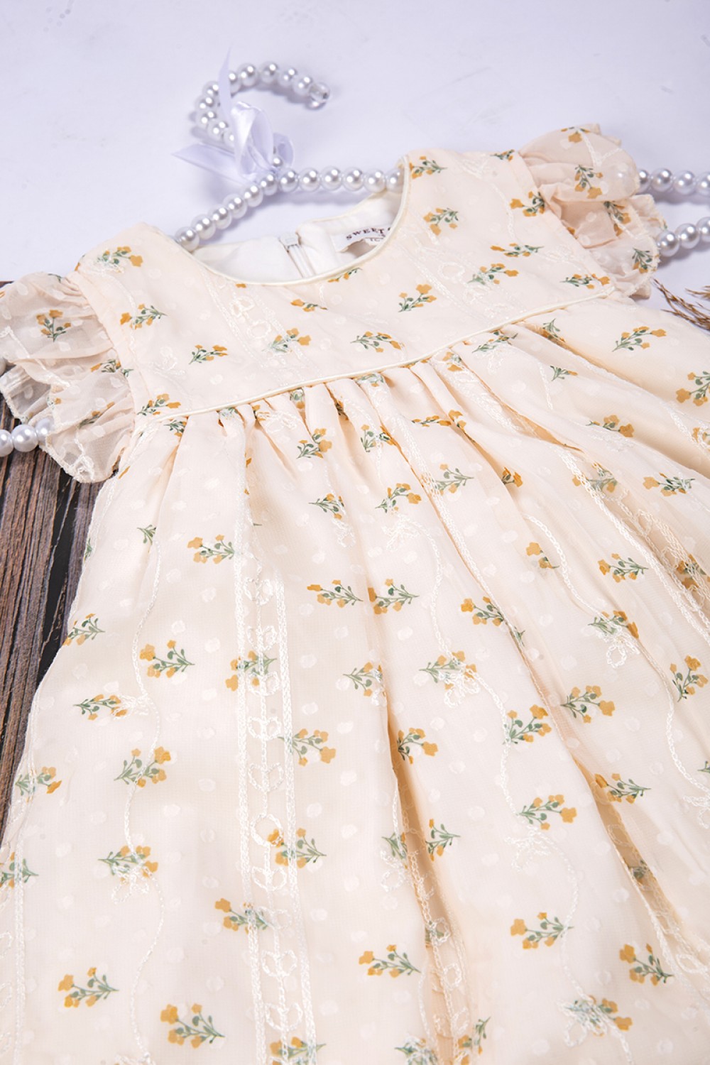 Elegant beige girl's dress with short sleeves and a round chest opening ...