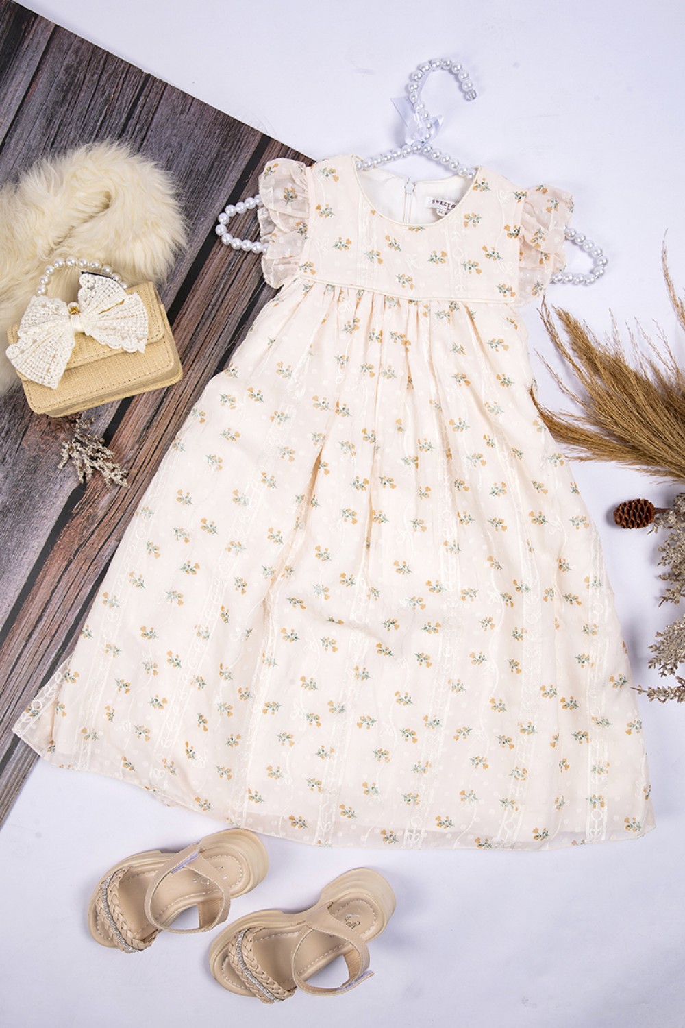 Elegant beige girl's dress with short sleeves and a round chest opening ...
